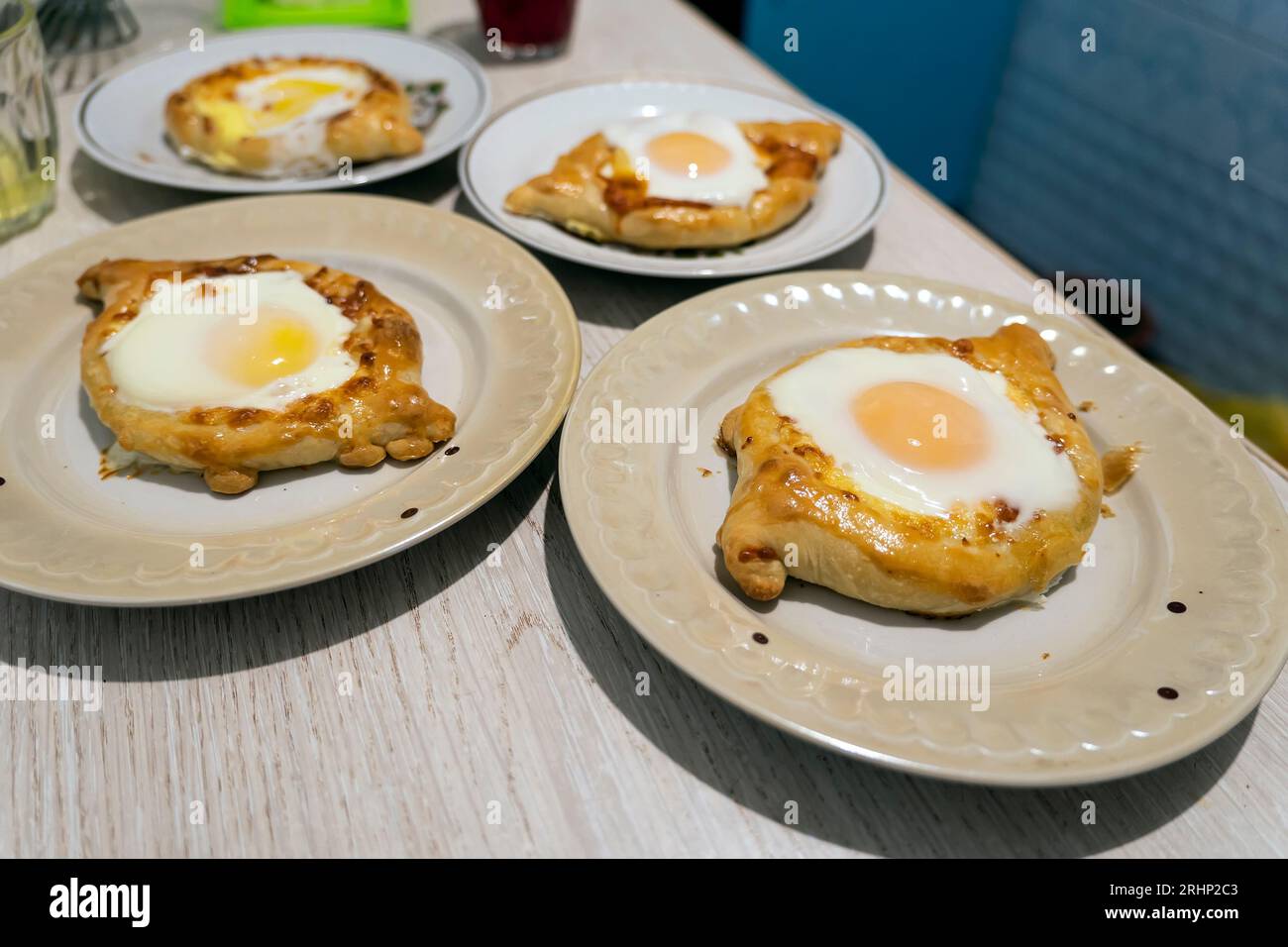 Traditional Georgian bread - khachapuri madjarski with cooker hand ...