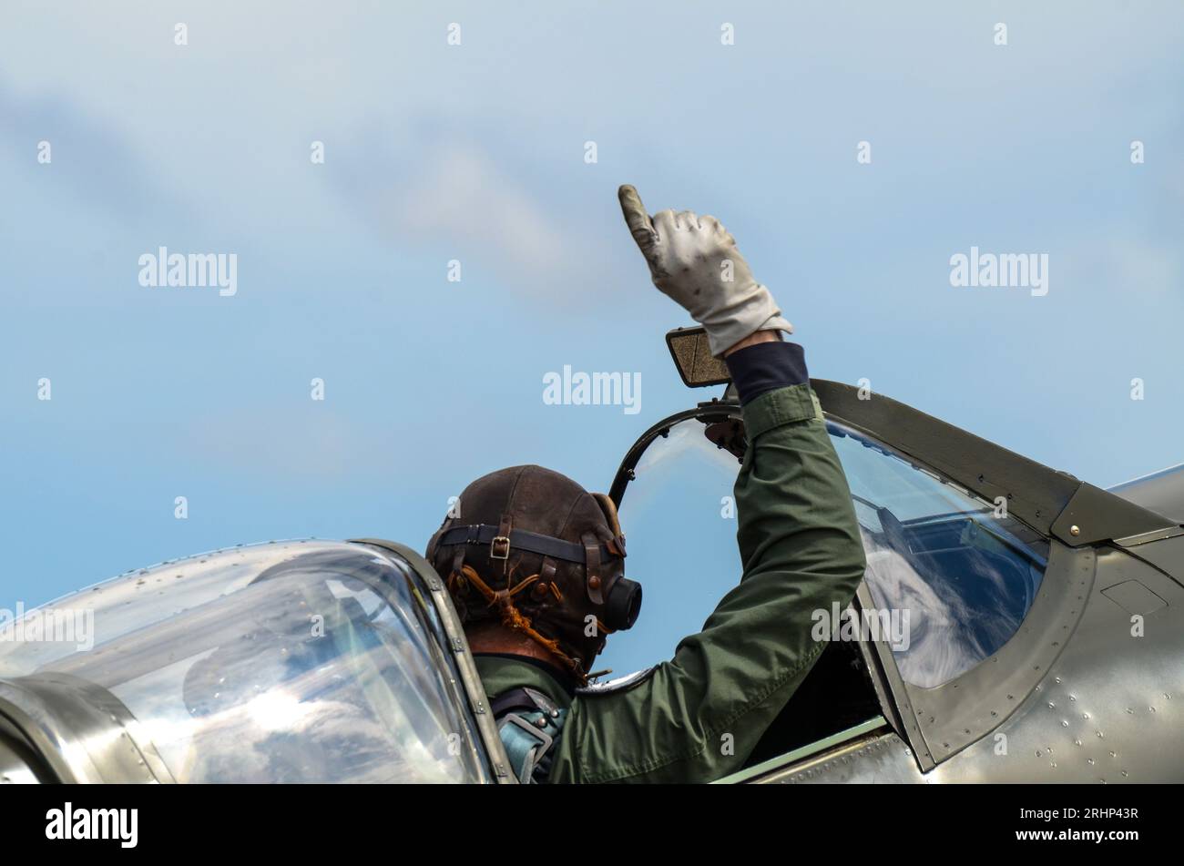 Pilot giving the universal engine propeller start hand signal prior to ...