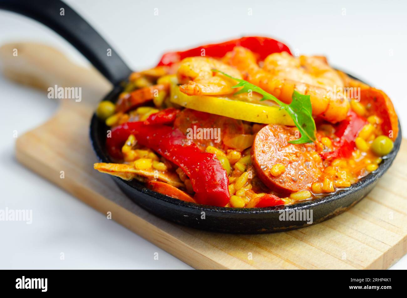 Delicious paella, cooked risotto rice with chicken thigh, king prawns ...