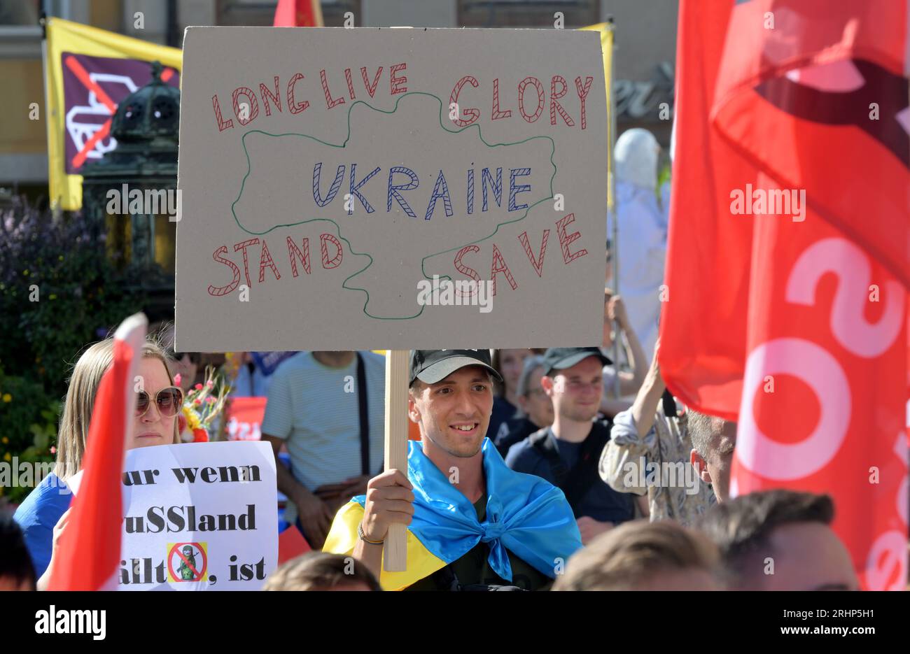 Munich, Germany. 18th Aug, 2023. Demonstrators hold placards before the ...