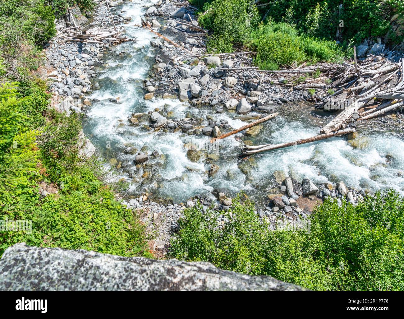 A river from a glacier flows under a highway in Mount Rainier National ...
