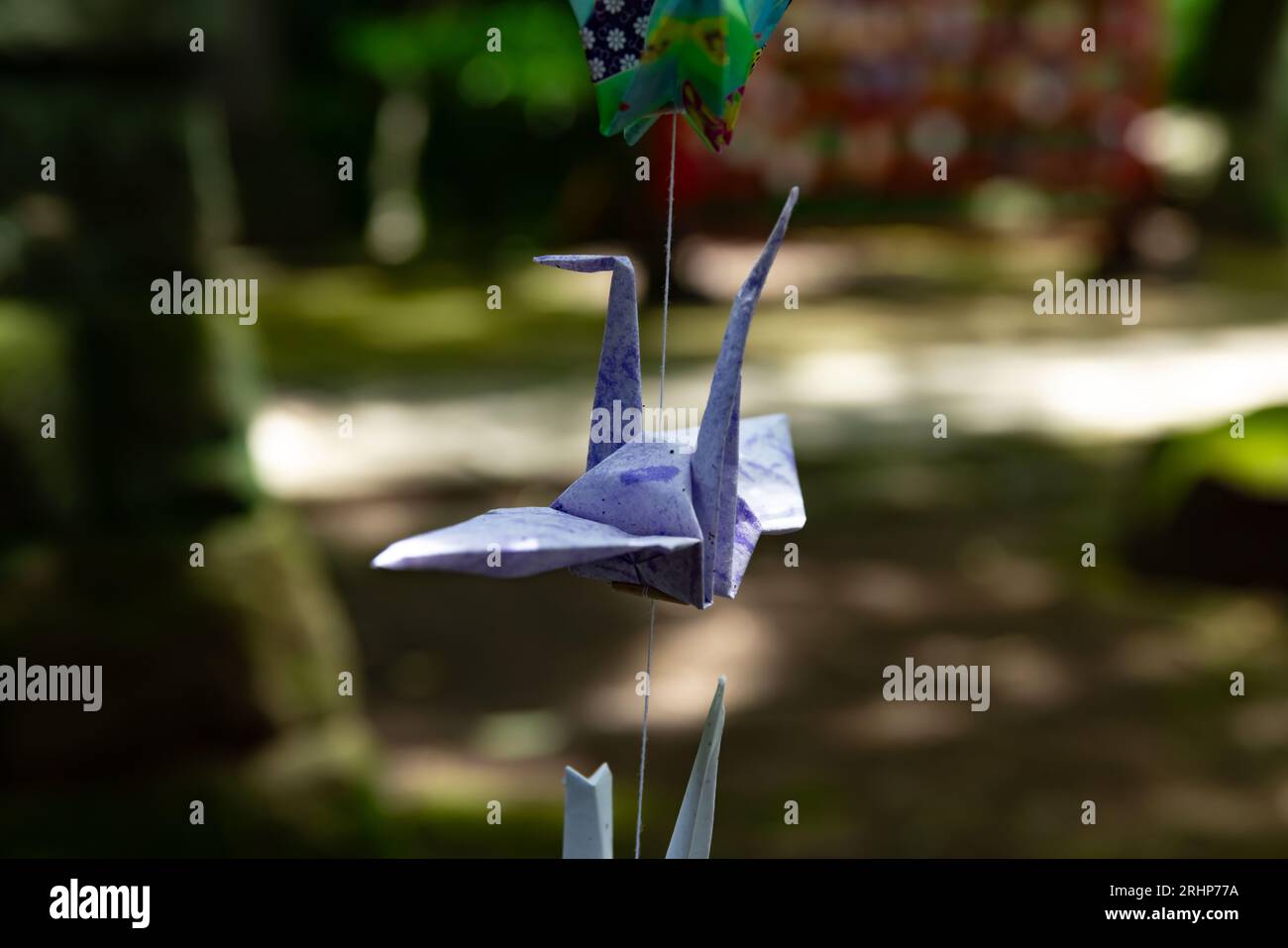 A paper crane swaying in the wind at the traditional street close up ...