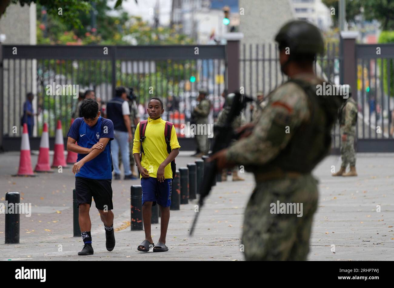 Students walk past soldiers standing guard inside a school in downtown ...