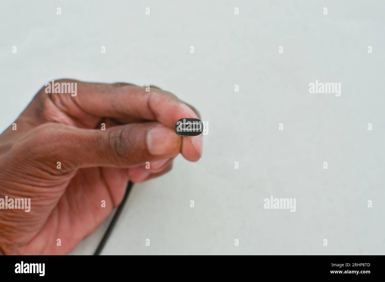 Black USB Type-C cable detail highlighted on a clear surface, perfect ...