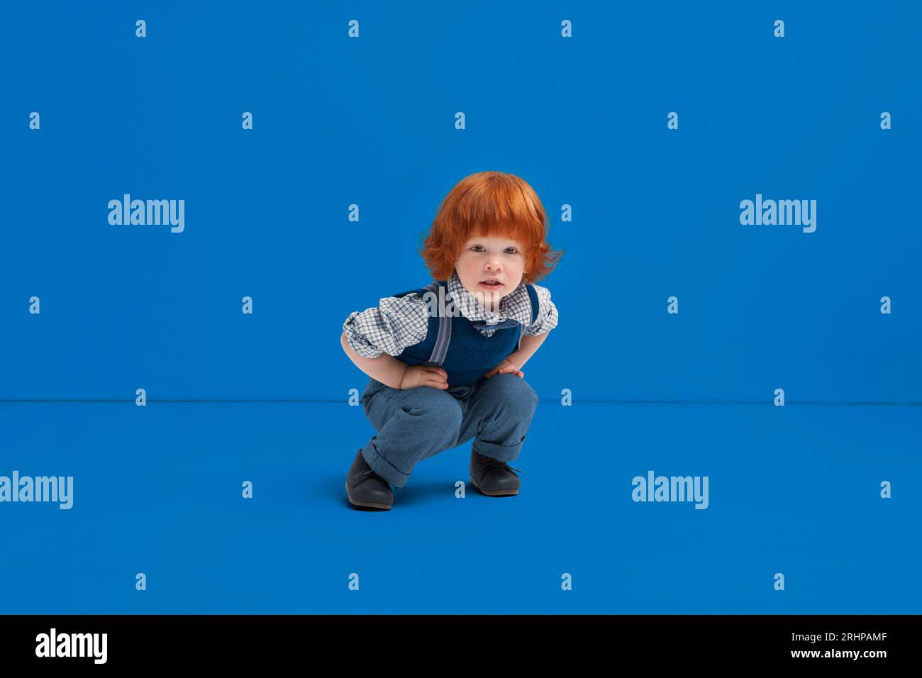 Child sits in squat position Stock Photo - Alamy
