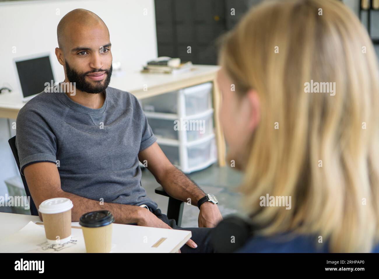 Work colleagues in conversation Stock Photo - Alamy