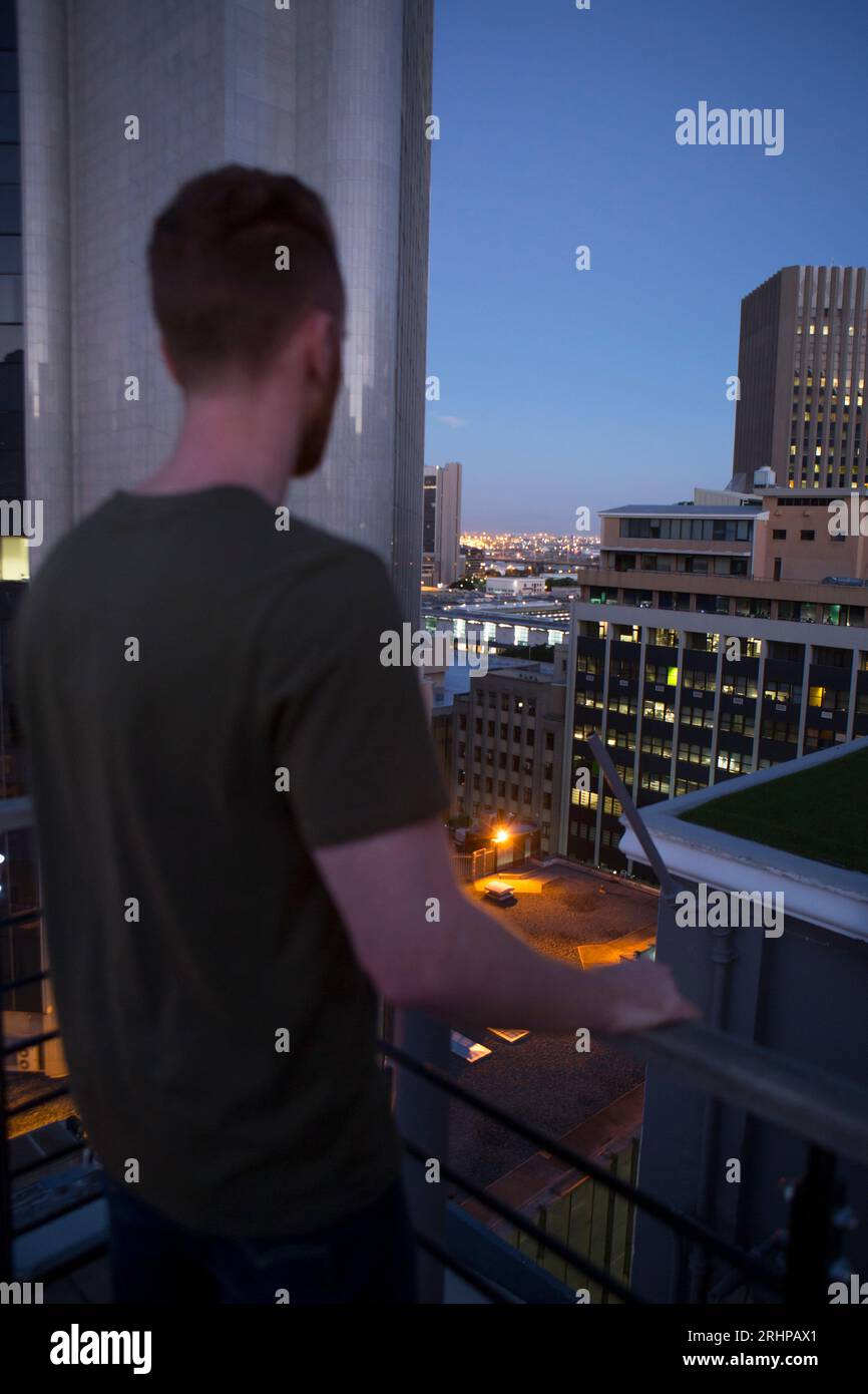 Man on roof terrace Stock Photo - Alamy