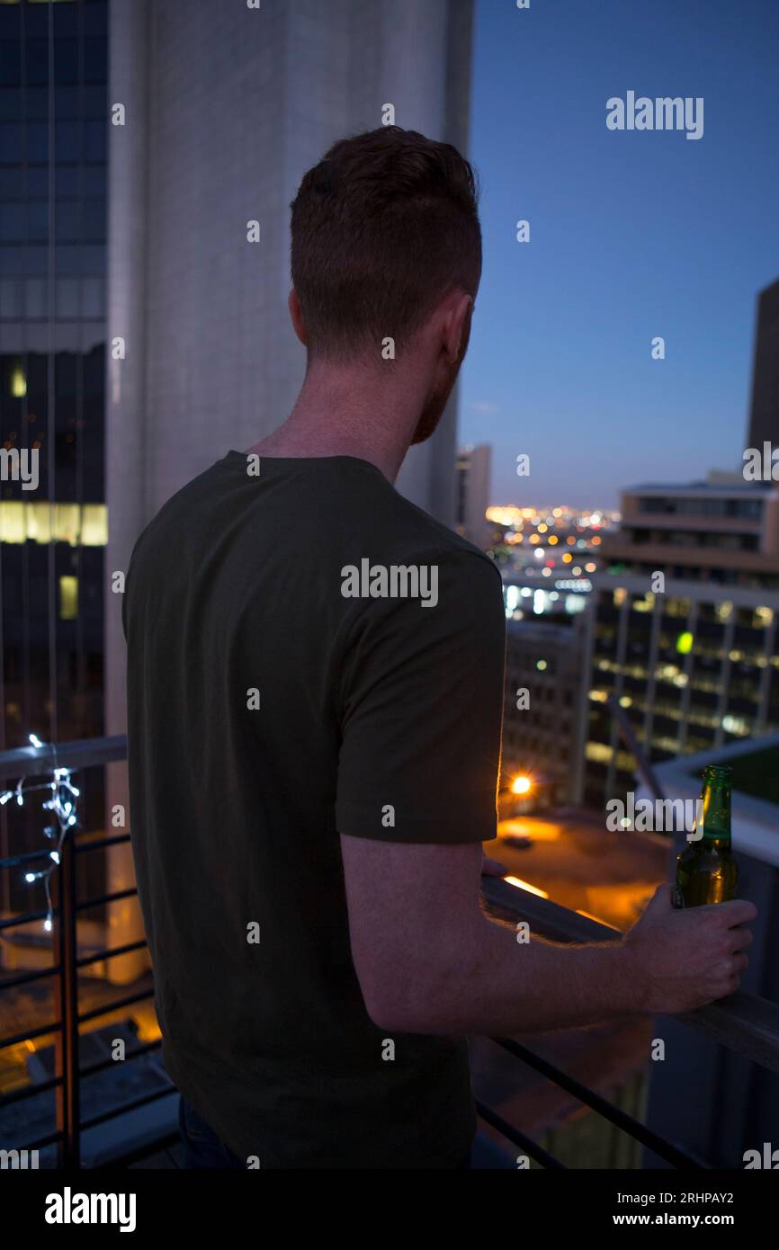 Man on roof terrace Stock Photo - Alamy