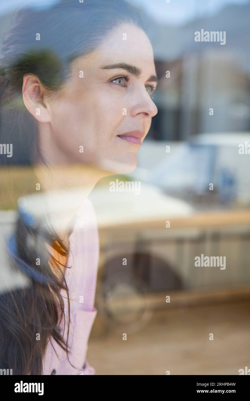 Exhausted woman looking out of window hi-res stock photography and ...
