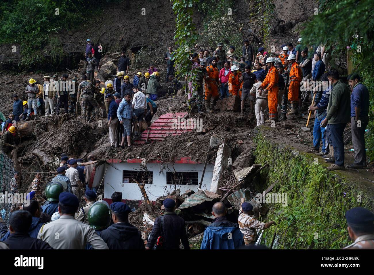 Rescuers remove mud and debris as they search for people feared trapped after a landslide near a ...