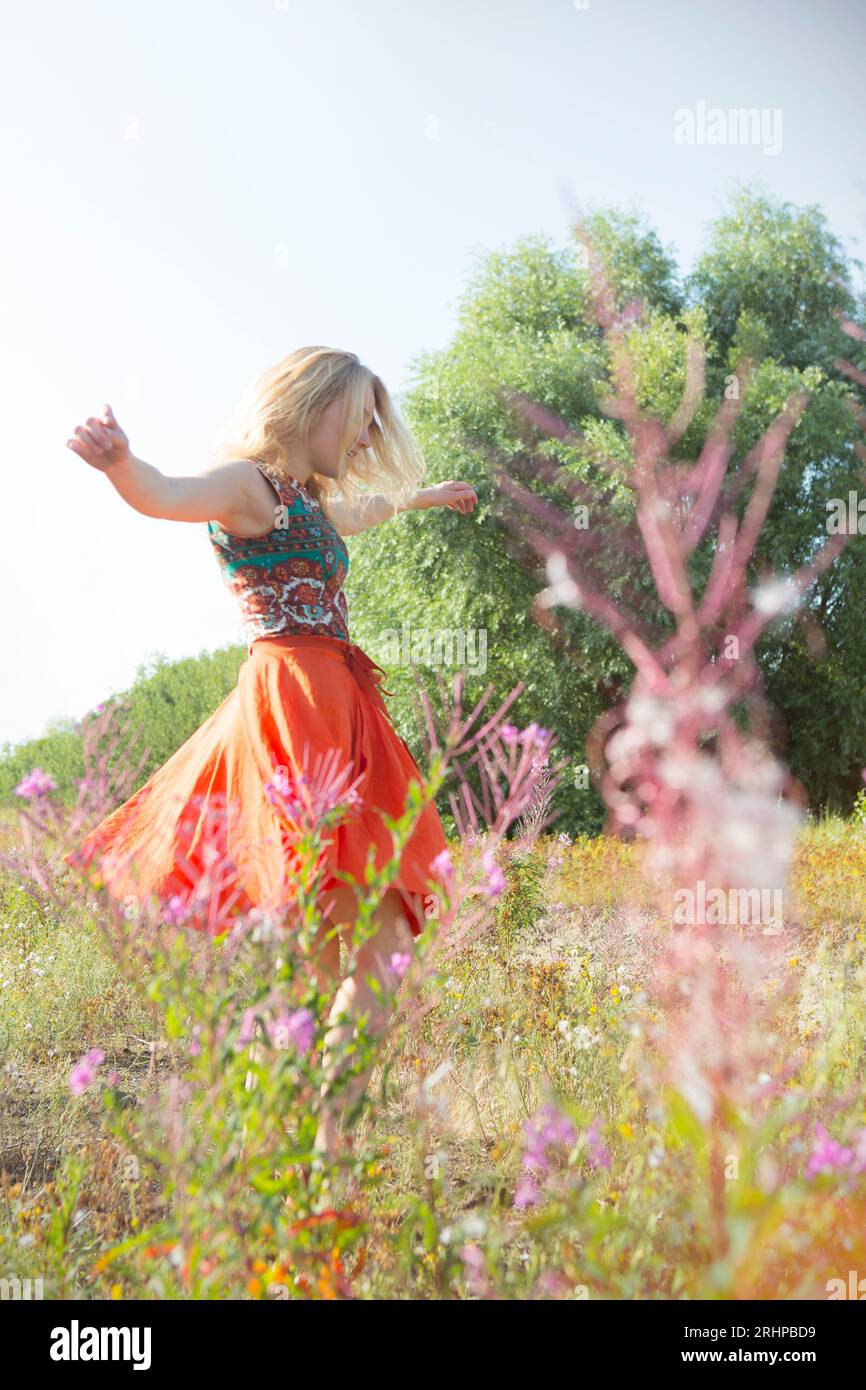 Happy blond woman dancing hi-res stock photography and images - Alamy