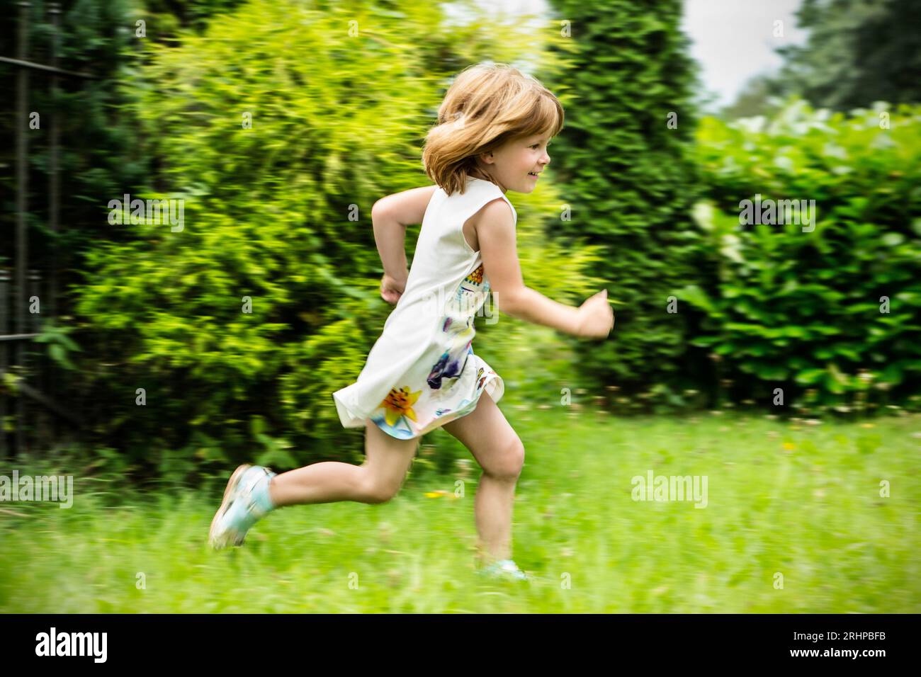 Girl running garden red hi-res stock photography and images - Alamy