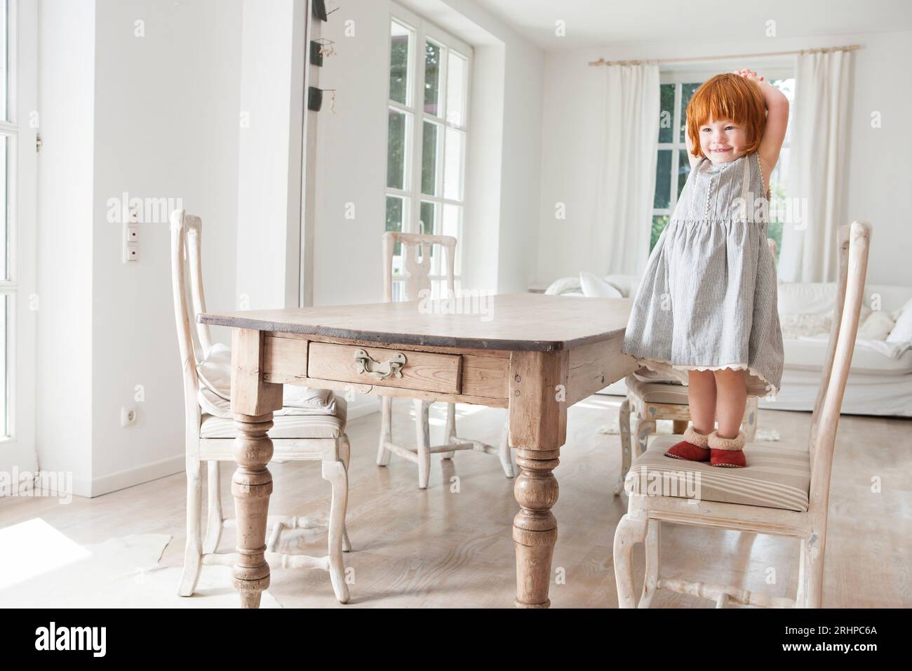 Girl at dining table Stock Photo - Alamy