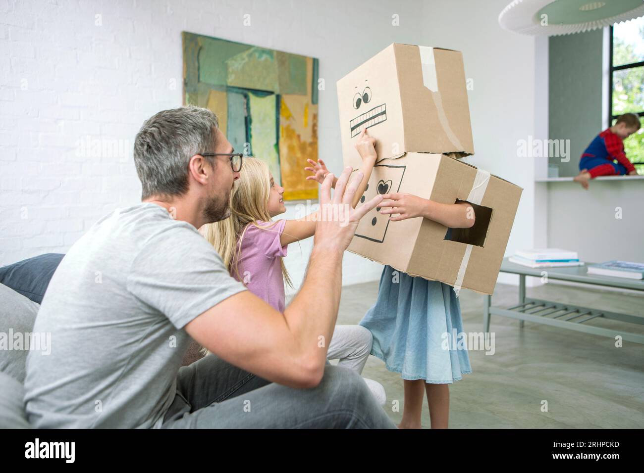Girl dressed as cardboard monster Stock Photo - Alamy