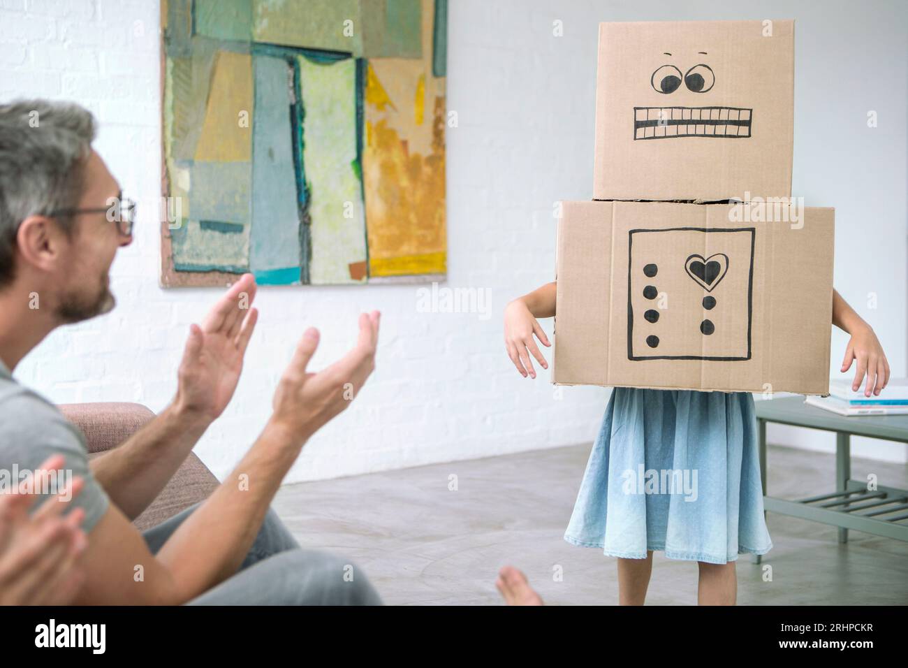 Girl dressed as cardboard monster Stock Photo - Alamy