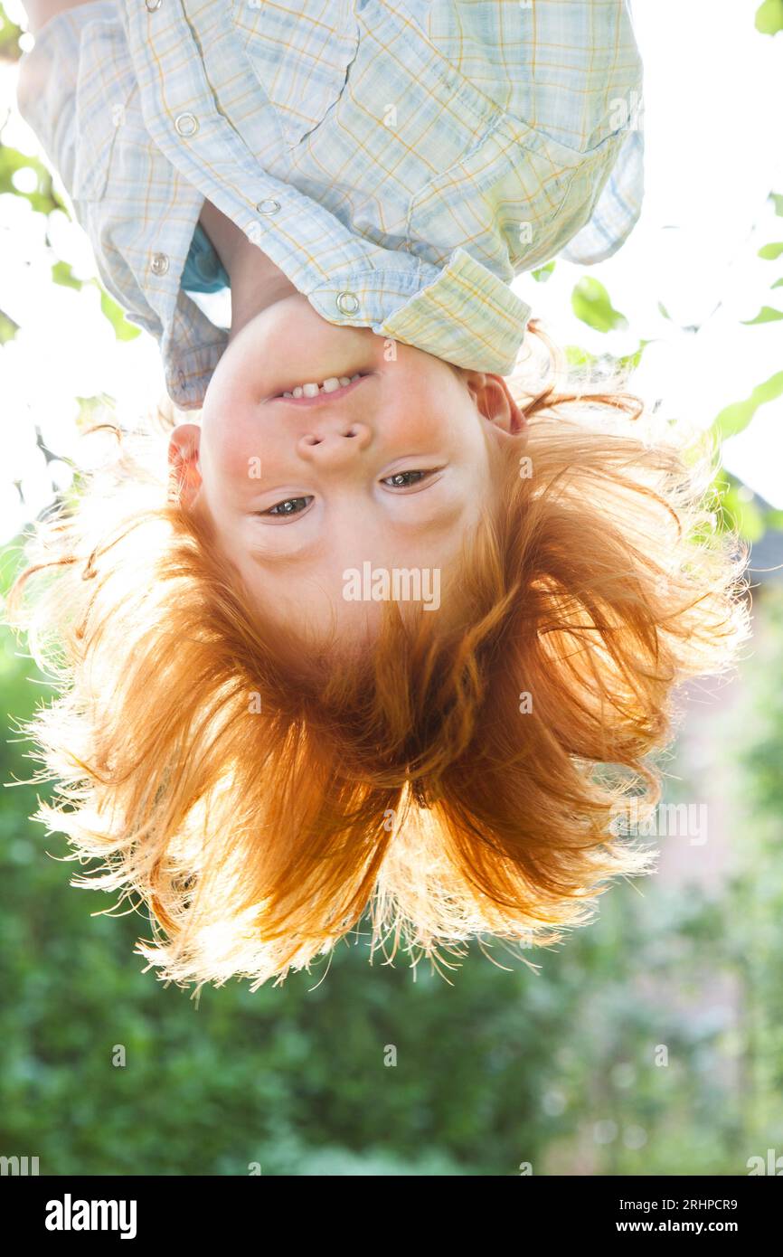 Child hangs over head Stock Photo - Alamy