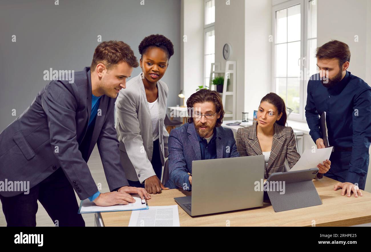 Teamwork of multiracial people working in progressive company on ...