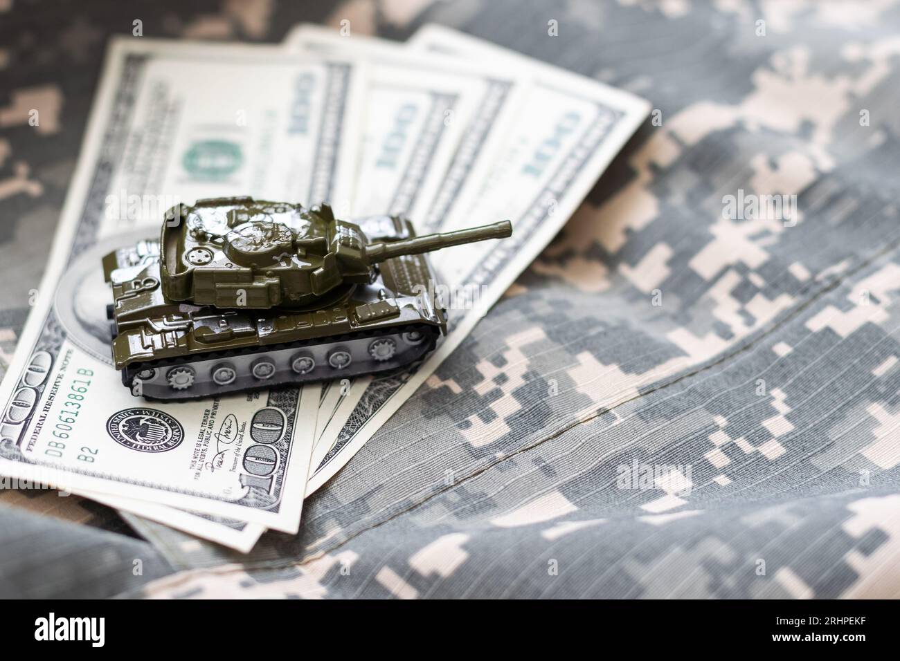toy tank on the background of dollar bills Stock Photo - Alamy