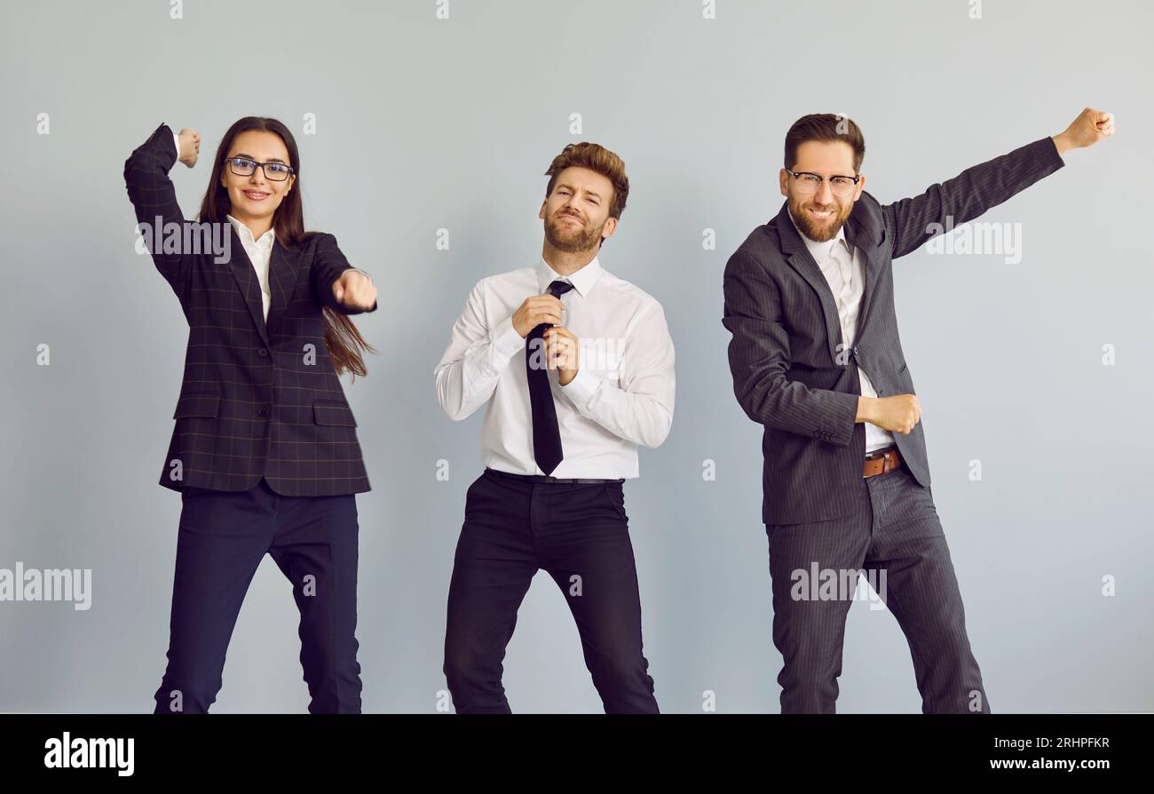 Three business people dancing and celebrate success in business ...