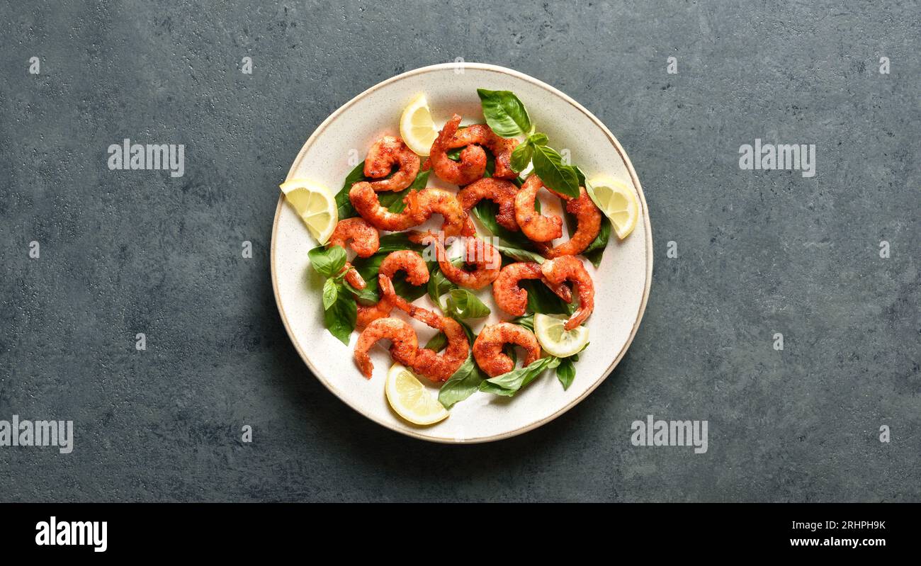 Spicy thai basil shrimp on plate over blue stone background with free ...