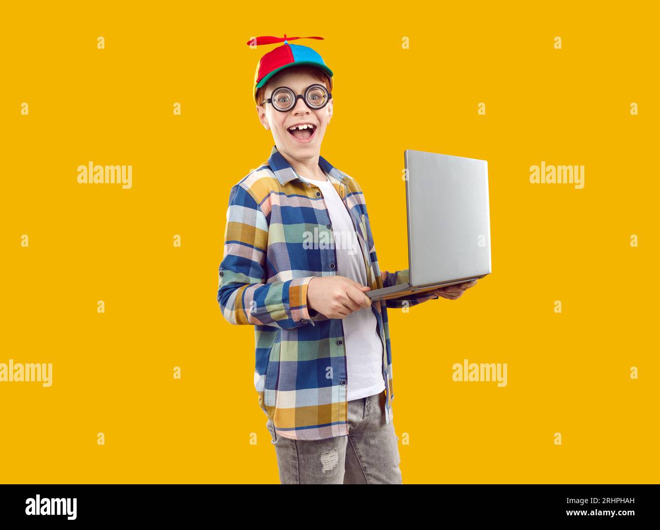 Portrait of funny nerd boy holding laptop computer Stock Photo - Alamy