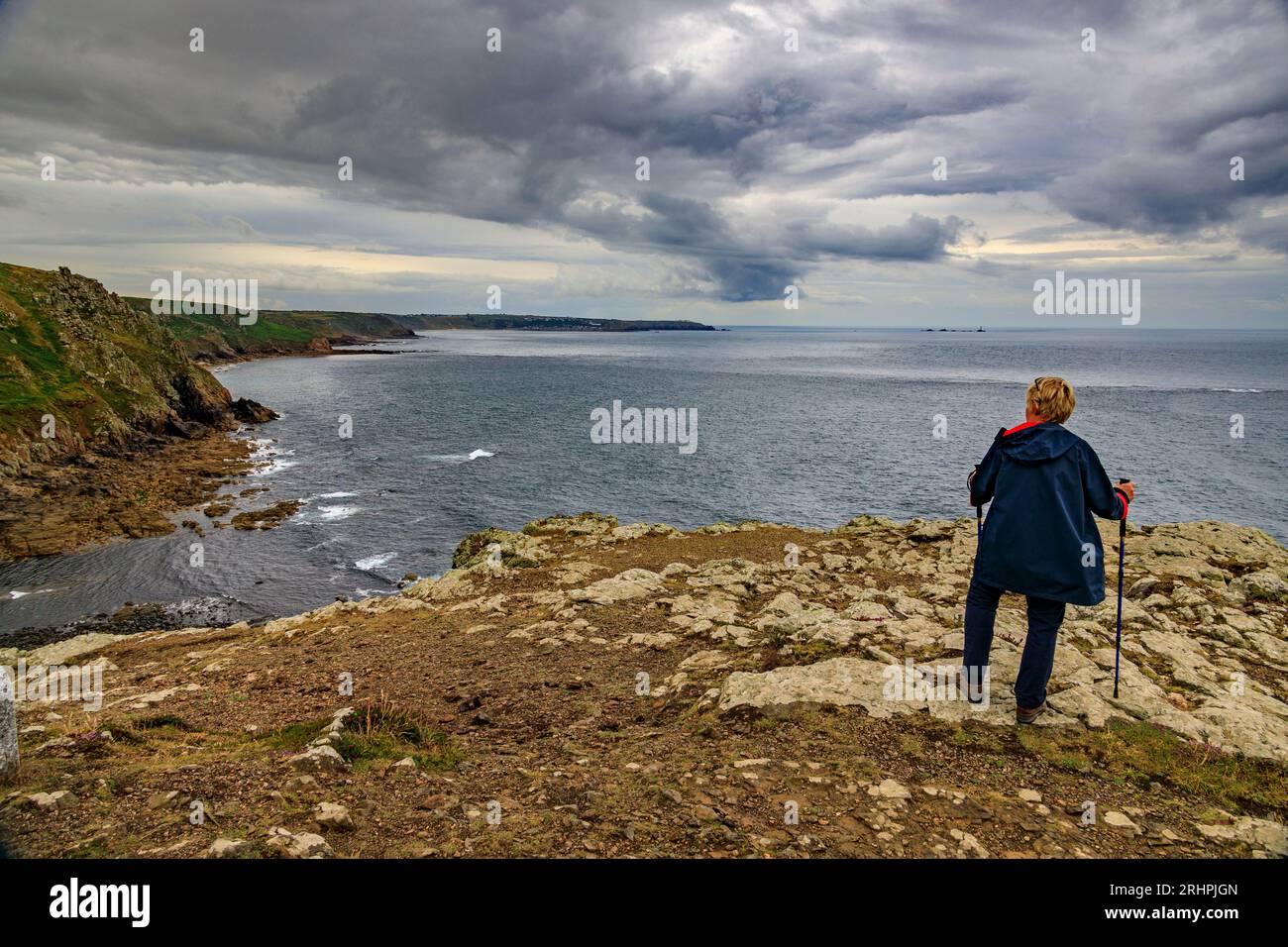 A walker looking south from Cape Cornwall towards Land's End and ...