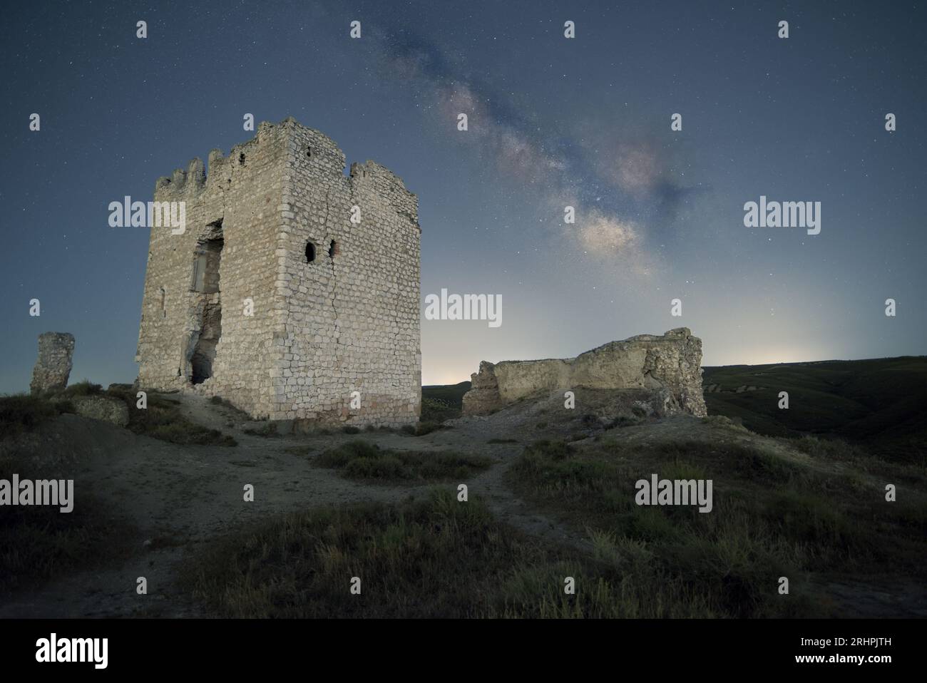 starry night sky with the Milky Way over an abandoned castle in the ...