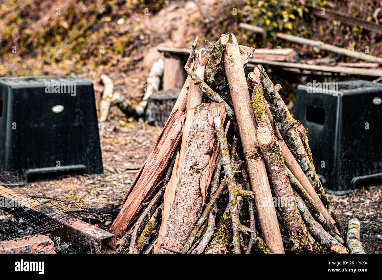 A bonfire at a camping site of a tourist resort. Empty plastic chairs ...