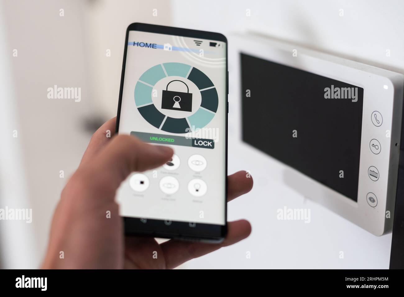 Smartphone with launched application for alarm security system, lock or ...