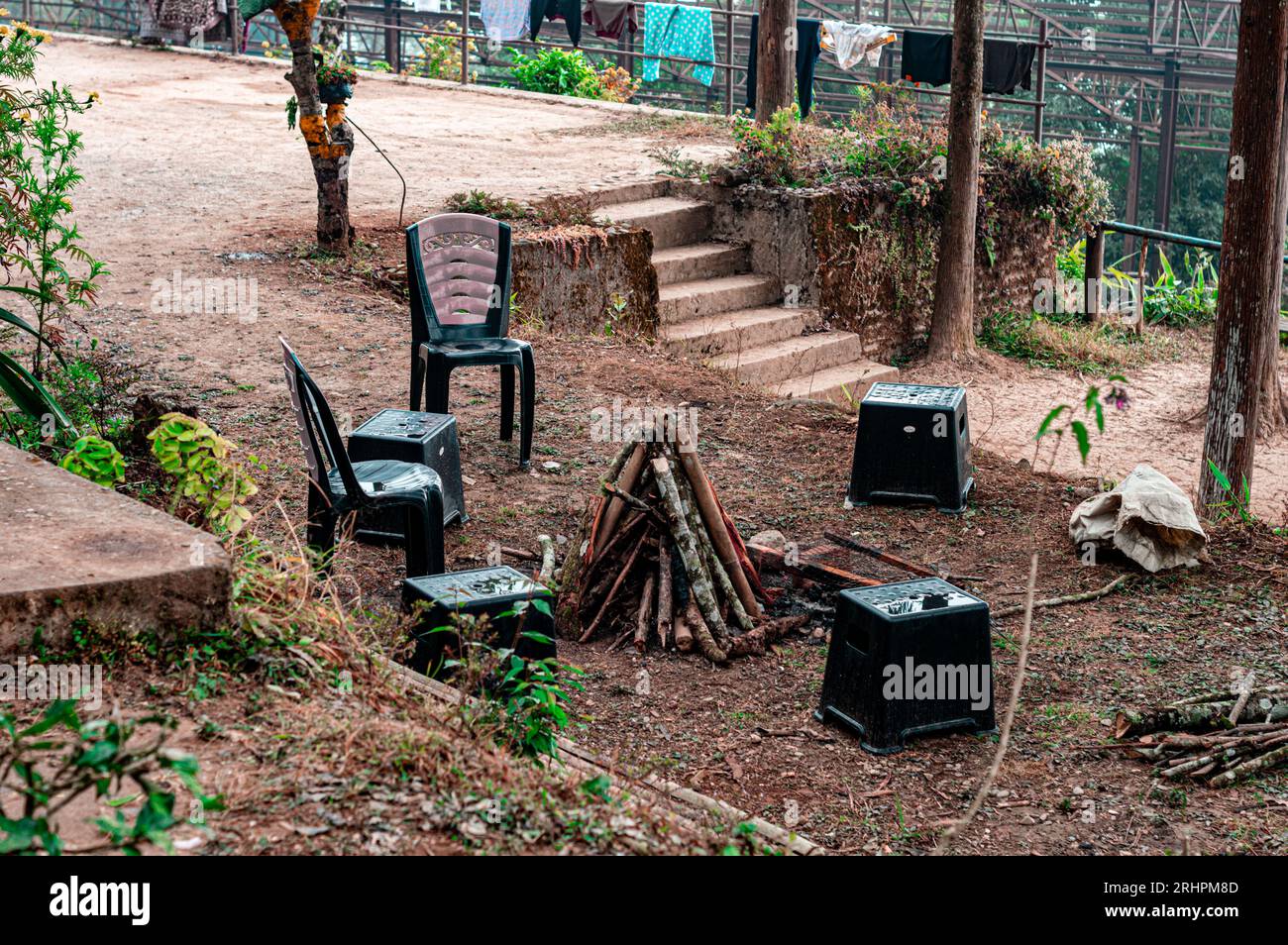A bonfire at a camping site of a tourist resort. Empty plastic chairs ...