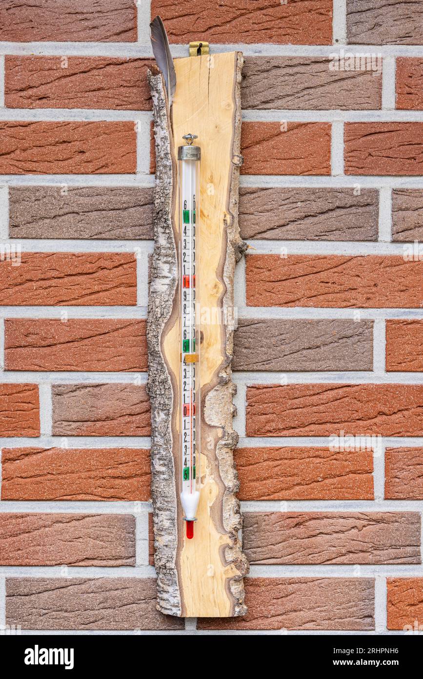 Old thermometer in wooden socket on a house wall, measure temperature ...