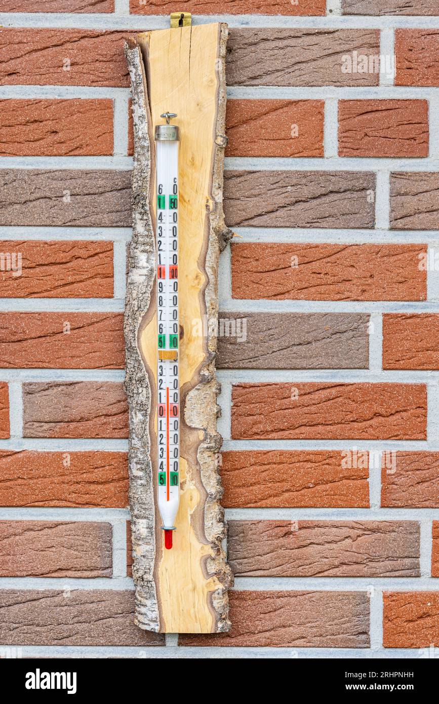 Old thermometer in wooden socket on a house wall, measure temperature ...