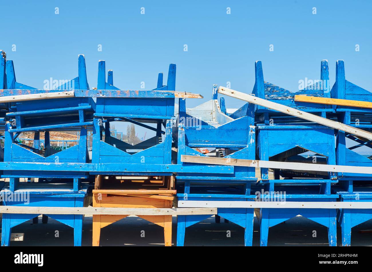 Pile of stacked beach blue white and yellow wooden sunbeds sun beds sun ...