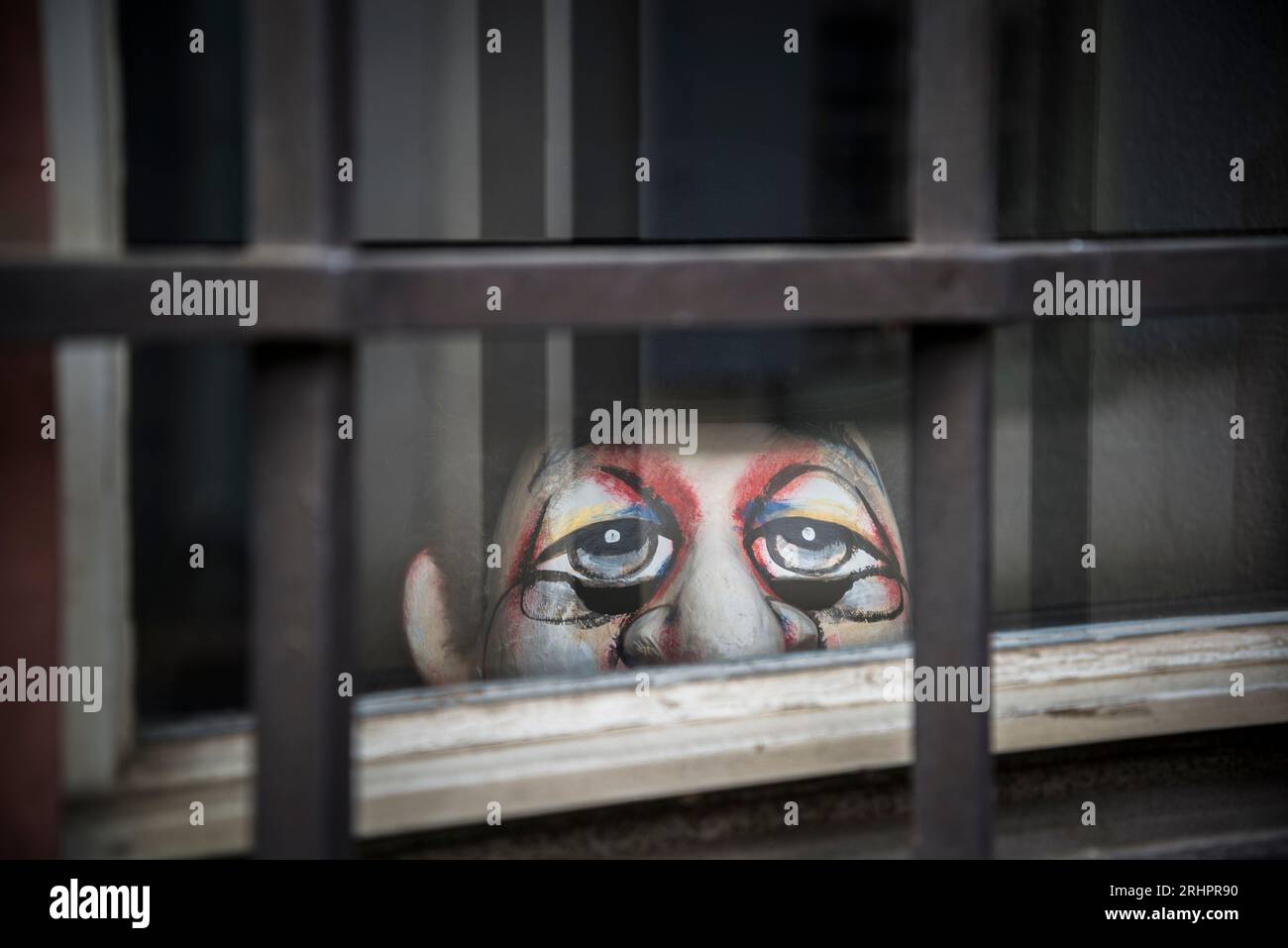 Mask of a sad face in a window Stock Photo - Alamy