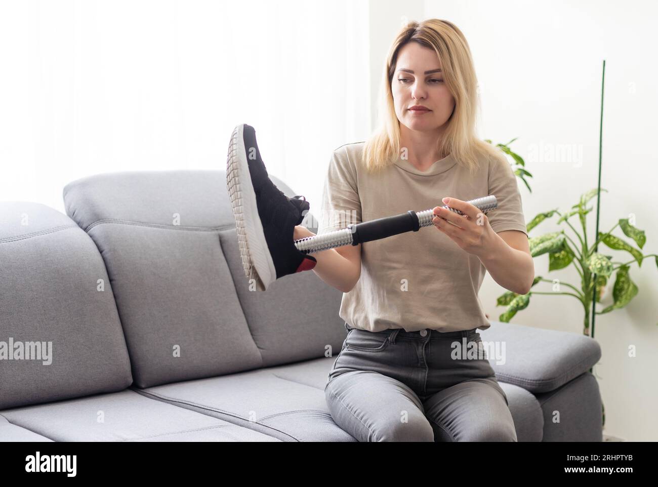 Female technician assembling and fixing parts of modern prosthetic leg ...