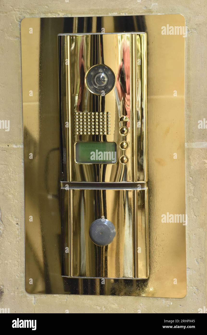 Brightly polished brass doorbell and intercom with TV facility, of a ...