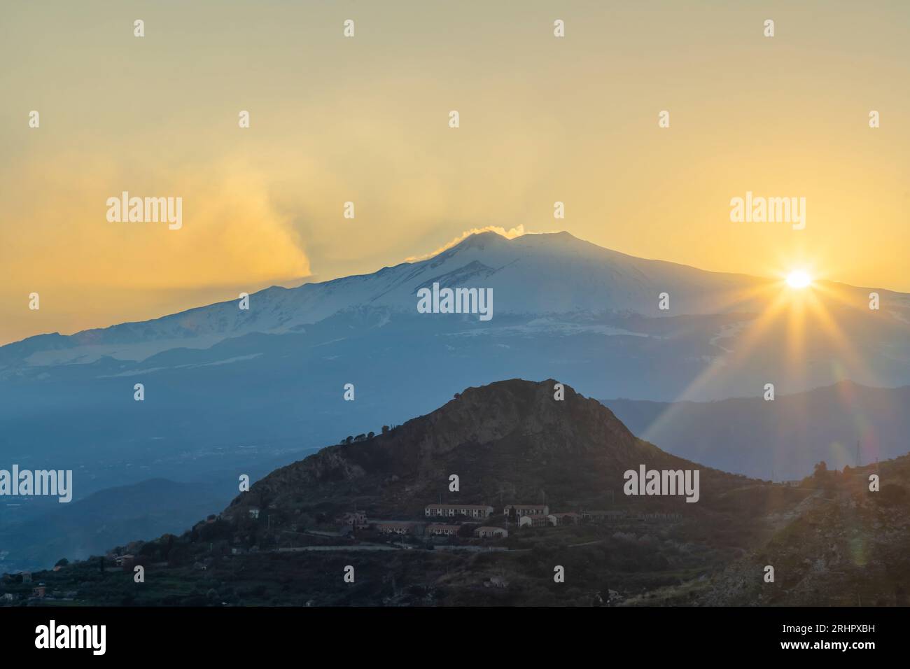 Sunset behind smoking Etna, observed from Taormina, Sicily Stock Photo ...