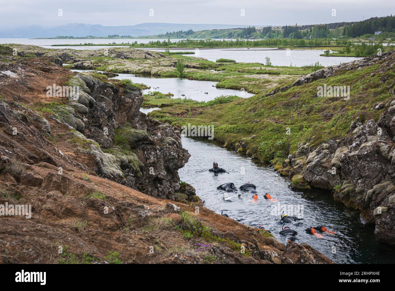 Southwest Iceland in early summer 2021, snorkelers in Silfra Fissure ...