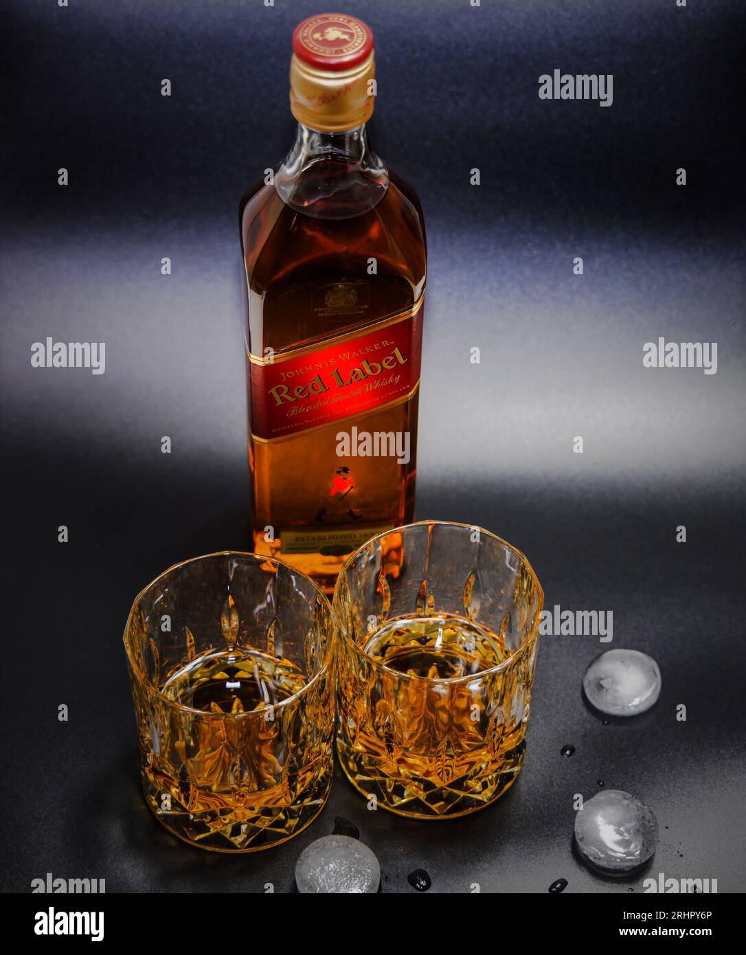 Two glasses of whiskey on the background of a bottle of wiskey Johnnie ...