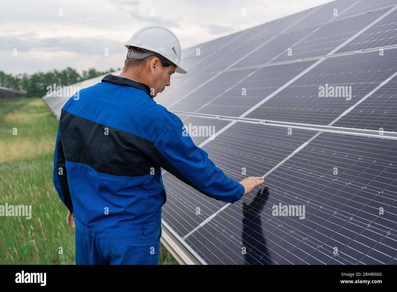 Service Engineer man touching solar panels. Technician maintenance ...