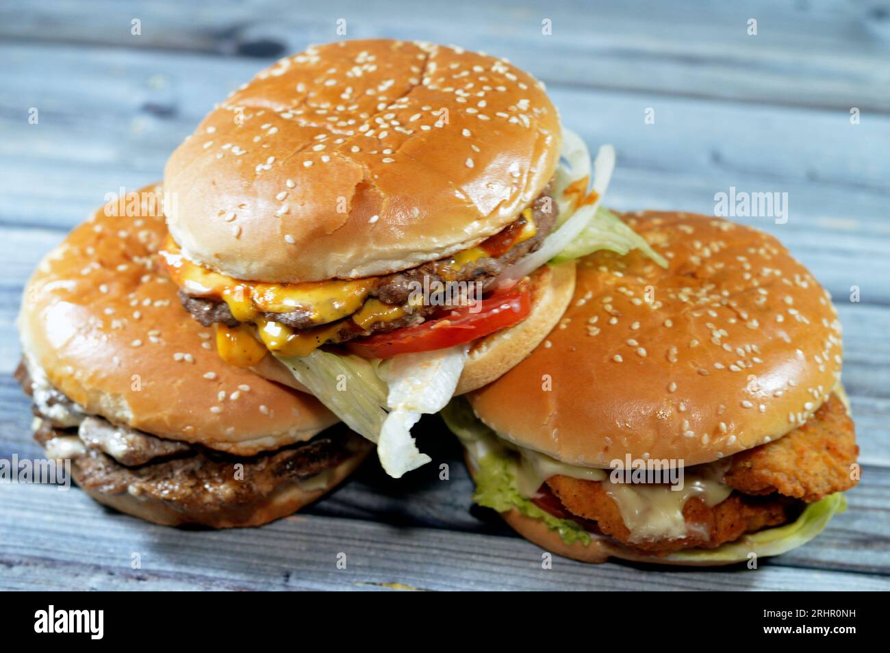 Pile of sesame buns of fried breaded chicken fillet patties, crisp ...