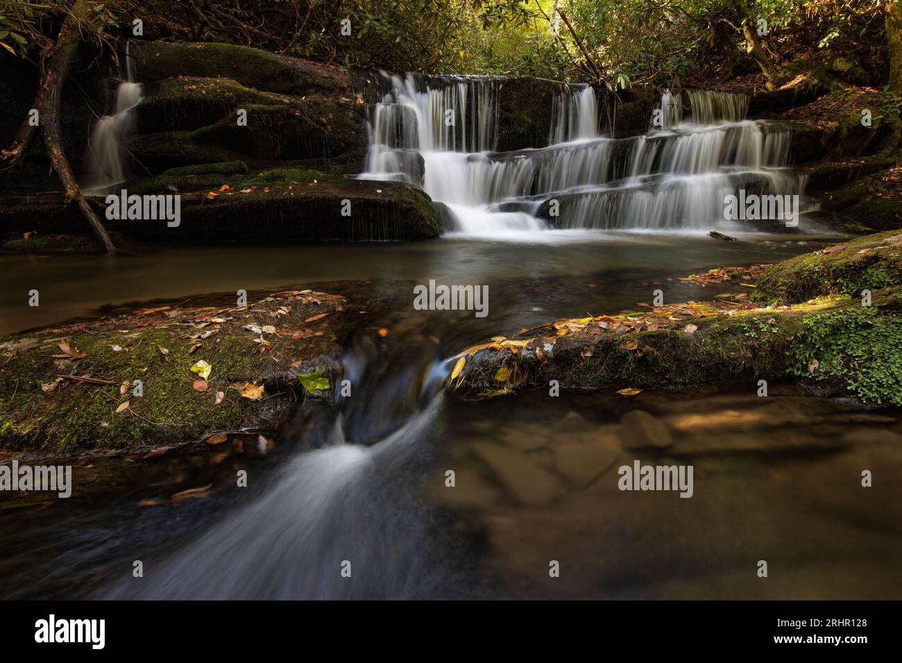 Water flows over the lower falls on Crow Creek under the shadows of a ...
