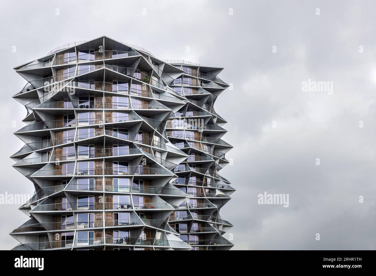 Tall modern residential building against a gray sky. Cactus tower in ...