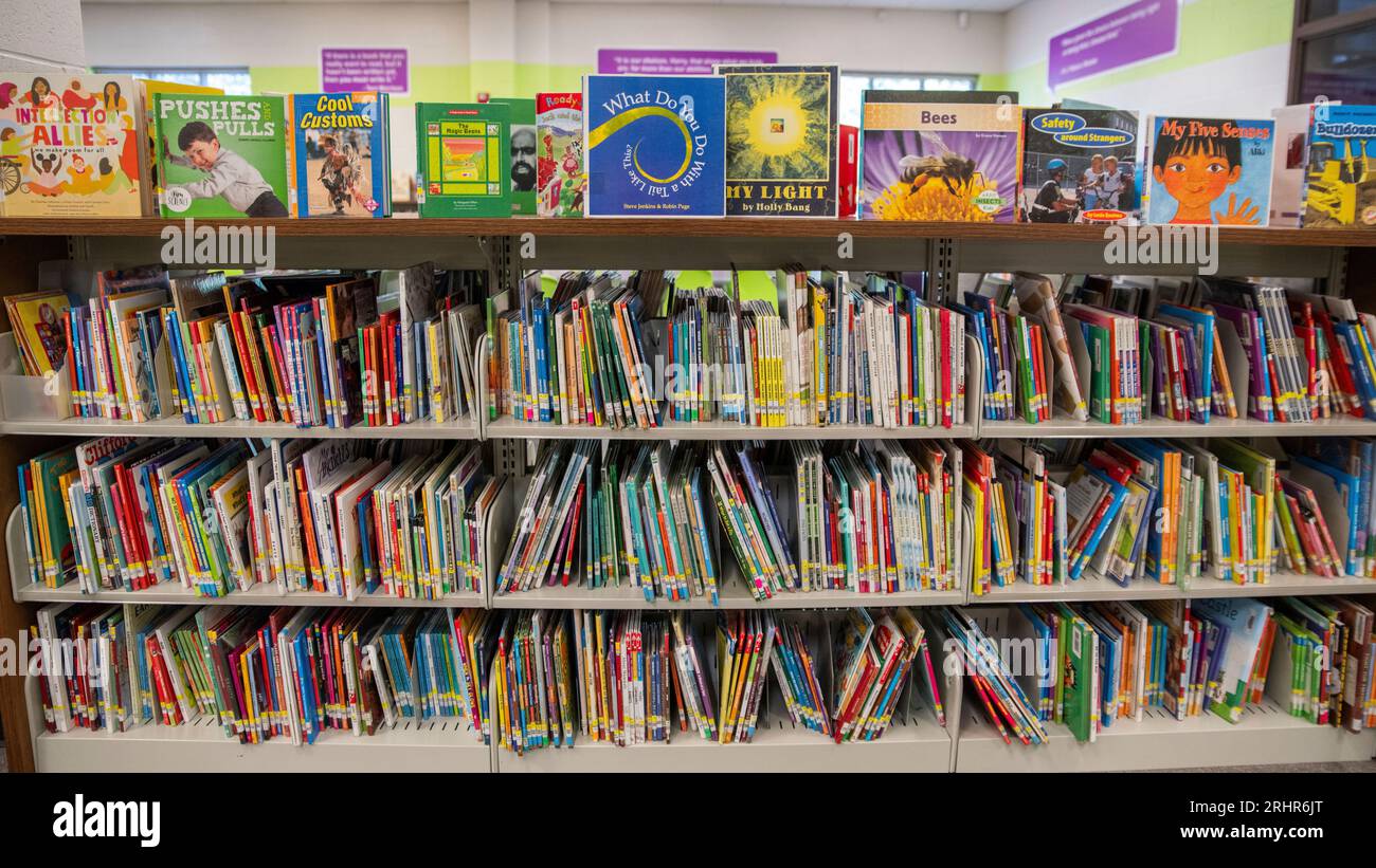 Books sit on shelves in an elementary school library in suburban ...