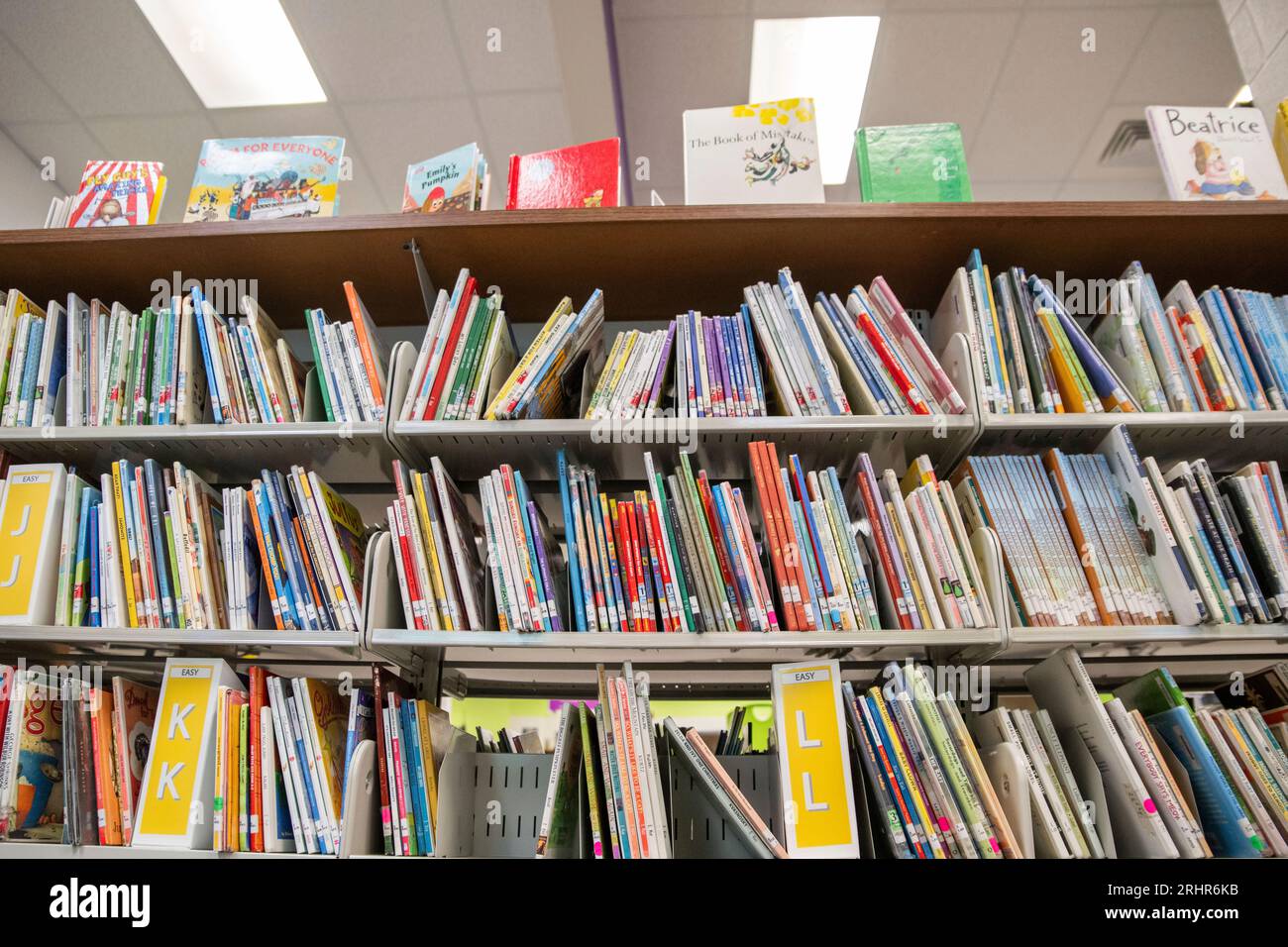 Books sit on shelves in an elementary school library in suburban ...