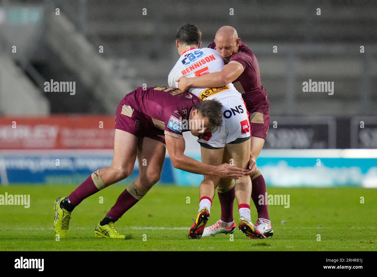 Rhys Kennedy #15 of Hull KR and Dean Hadley #22 of Hull KR tackle Jon ...