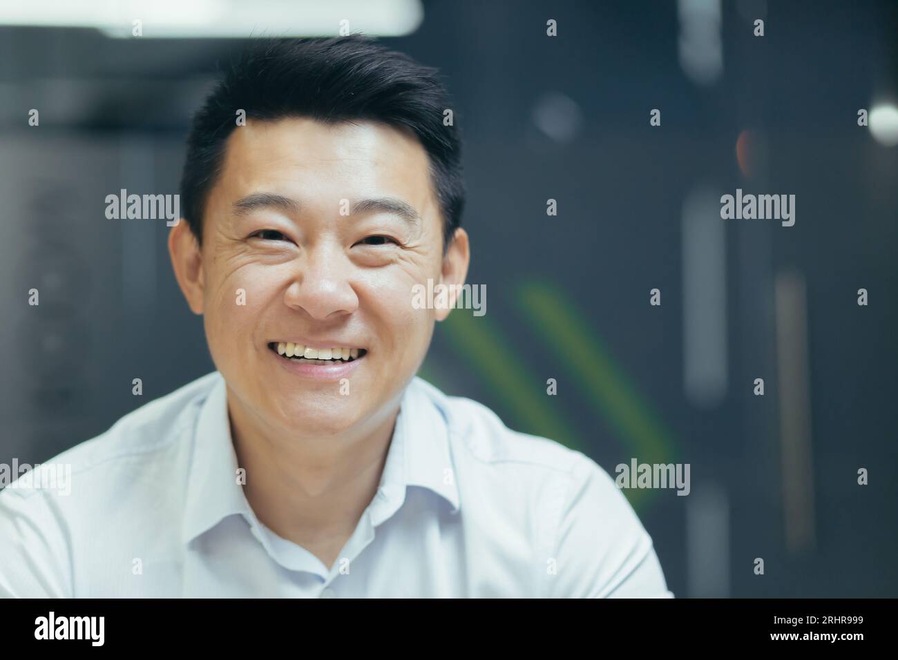 Close-up photo. Portrait of a young Asian man in a distressed shirt ...