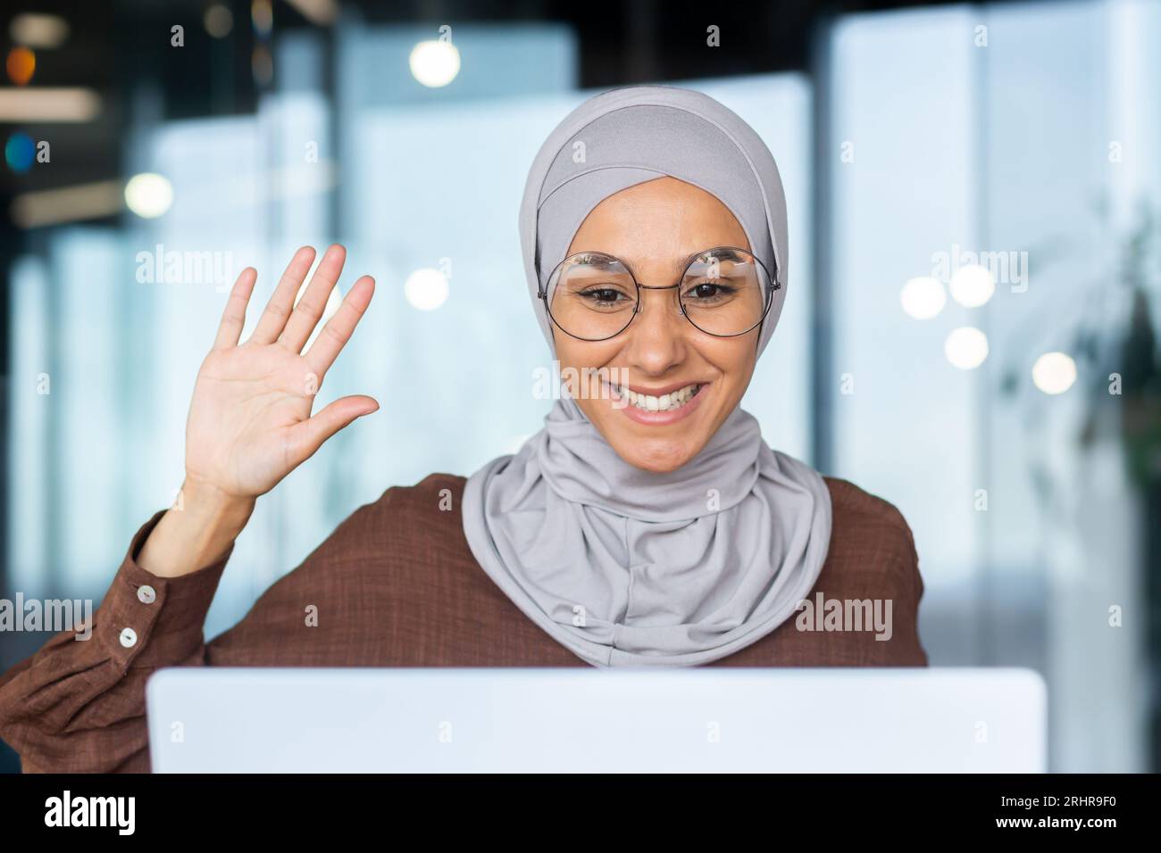 Young smiling muslim woman in hijab student talking on video call via ...