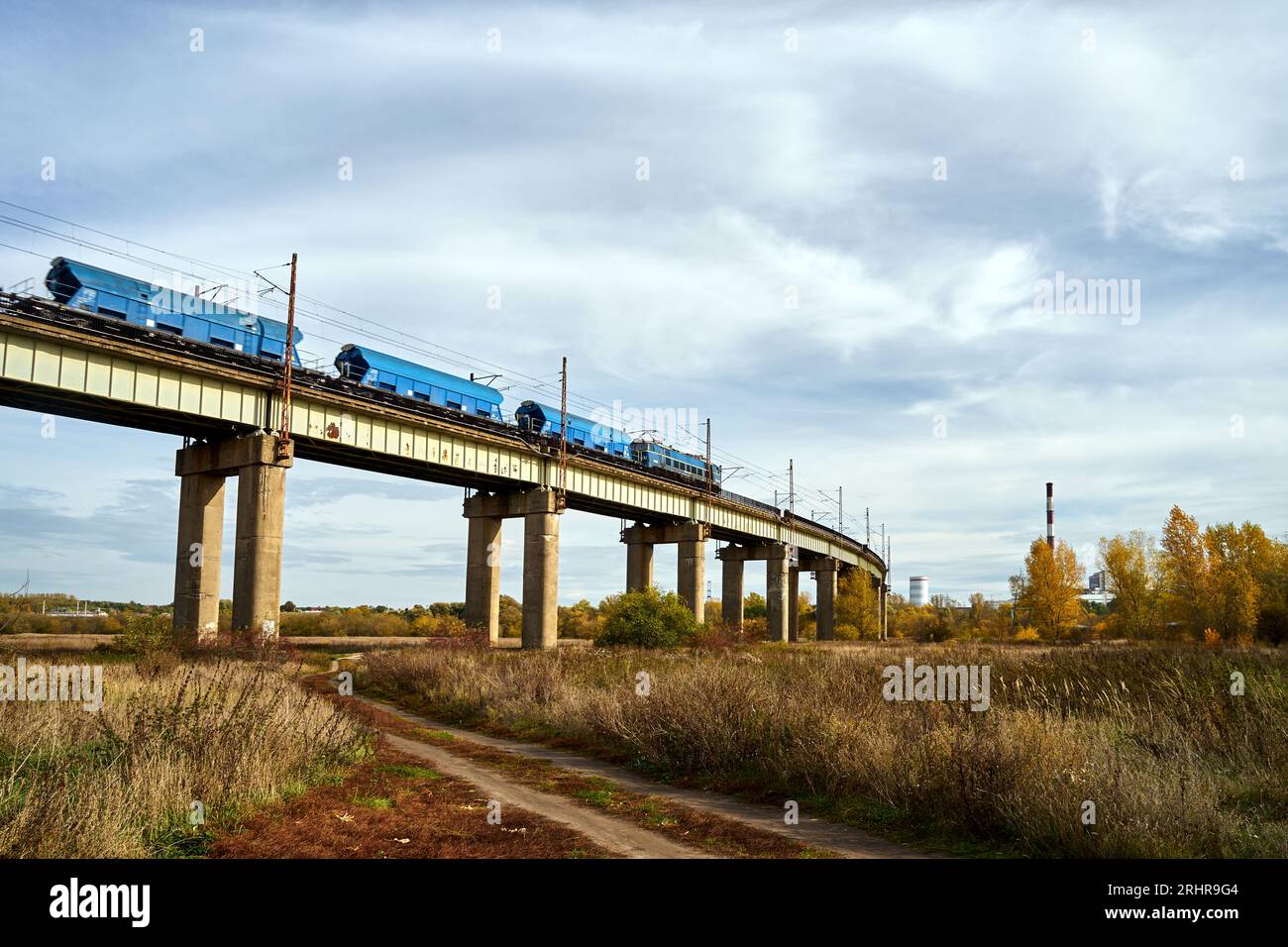 Freight train on a flyover over meadows near the city of Poznan, Poland ...