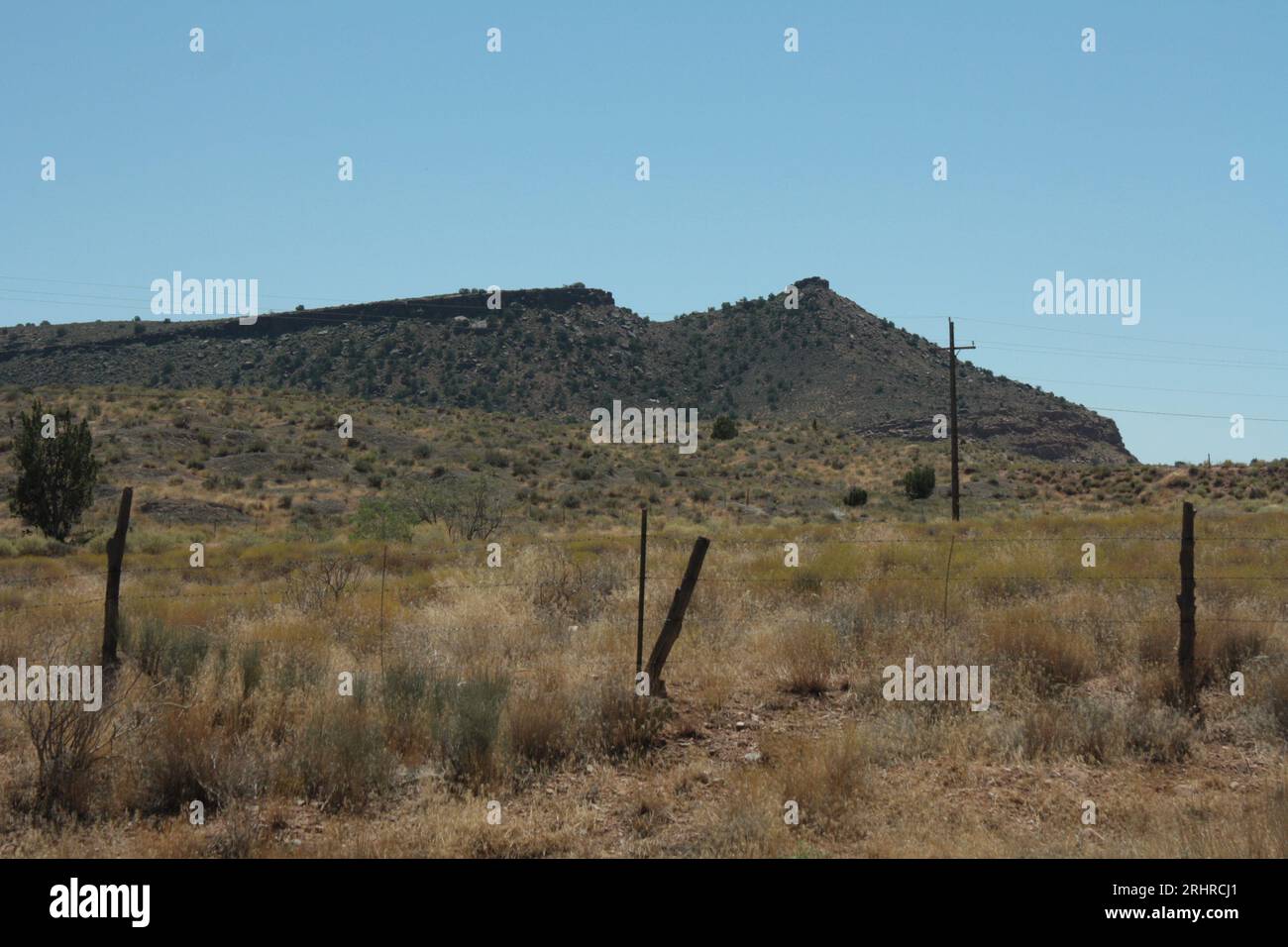 grassy field at the base of a hill Stock Photo - Alamy